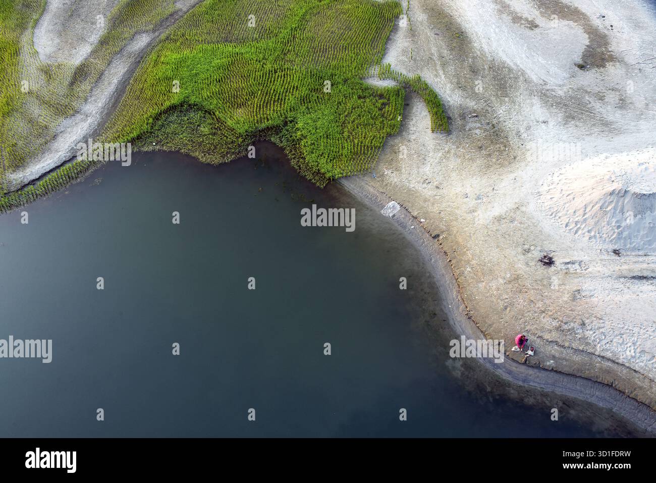 Aerial View Of Green Marsh Wetland Along Shallow Shoreline And Wate ...