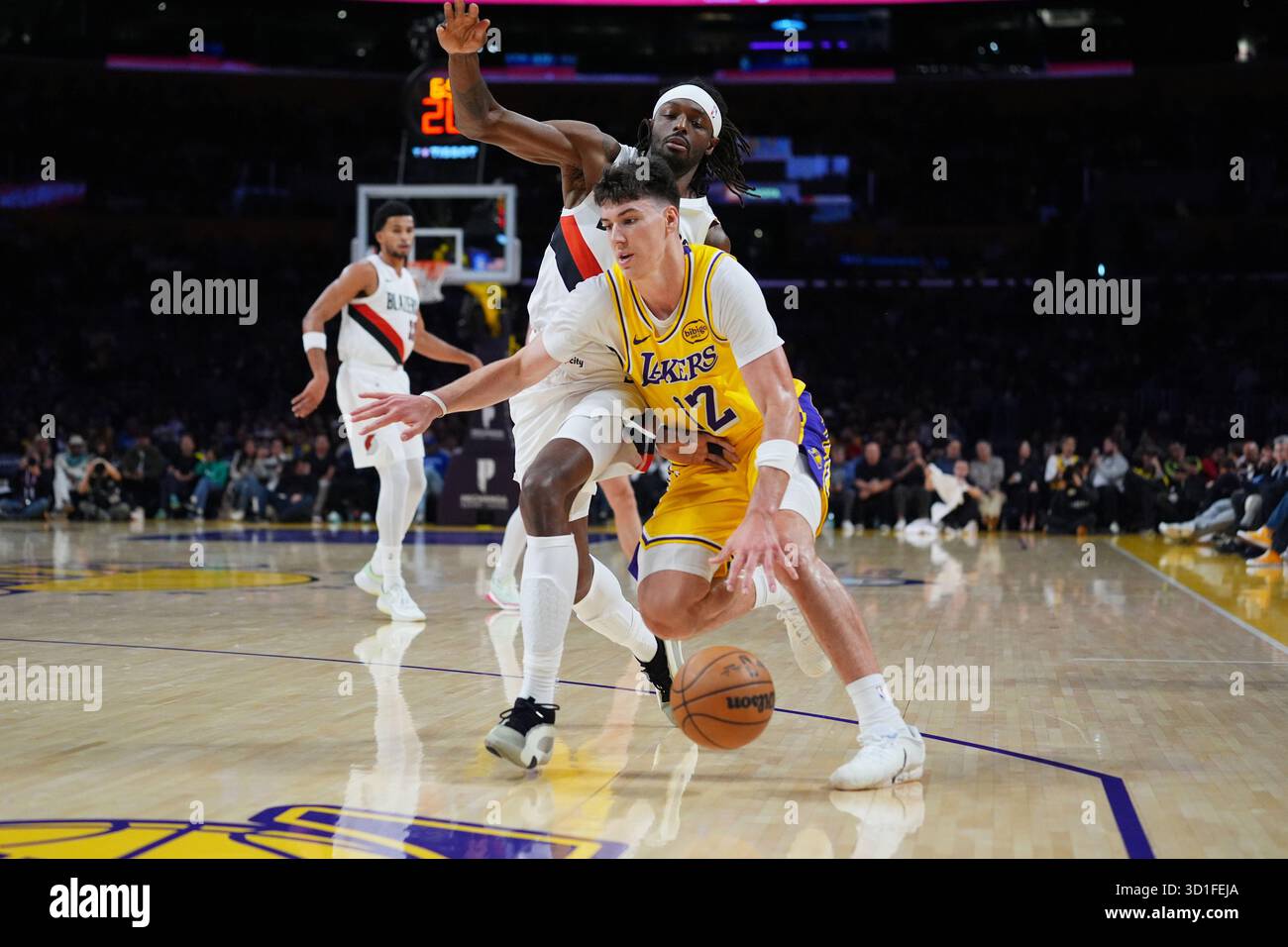 Los Angeles Lakers forward Jake LaRavia (12) drives the ball against ...