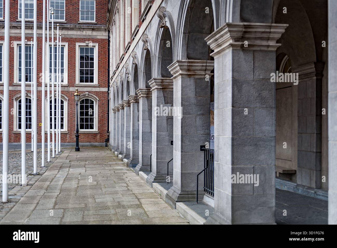 Elegant stone arcade with arched columns and red brick facade at Dublin ...