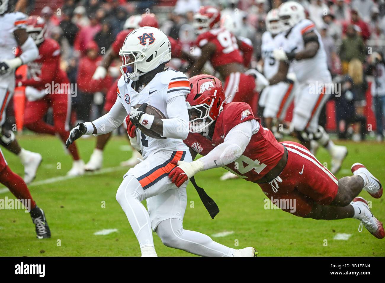 Auburn wide receiver Eric Singleton Jr. (1) tries to shake Arkansas ...