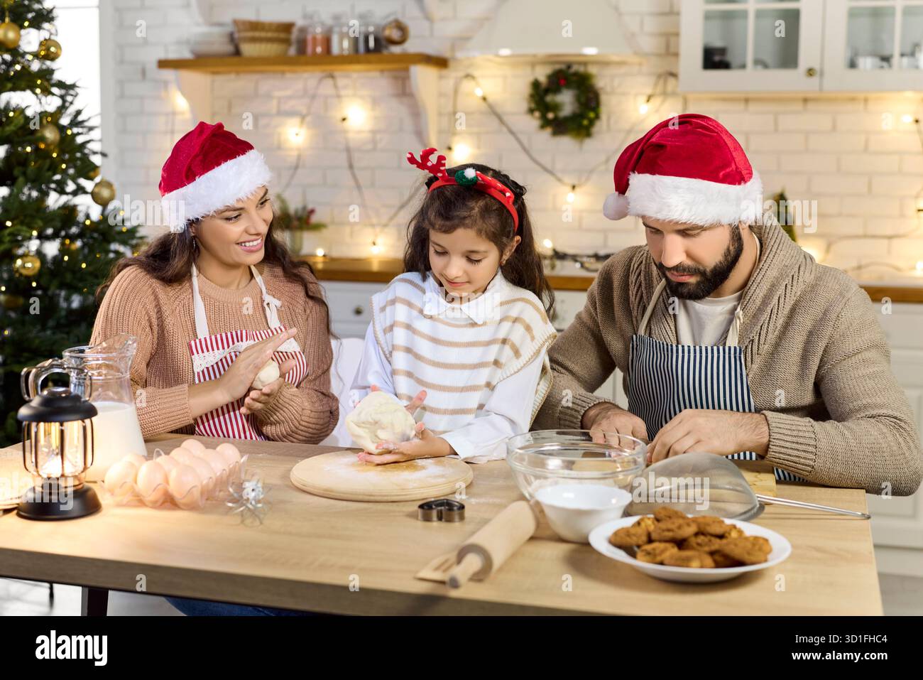 Happy family with daughter baking Christmas cookies together in cozy ...