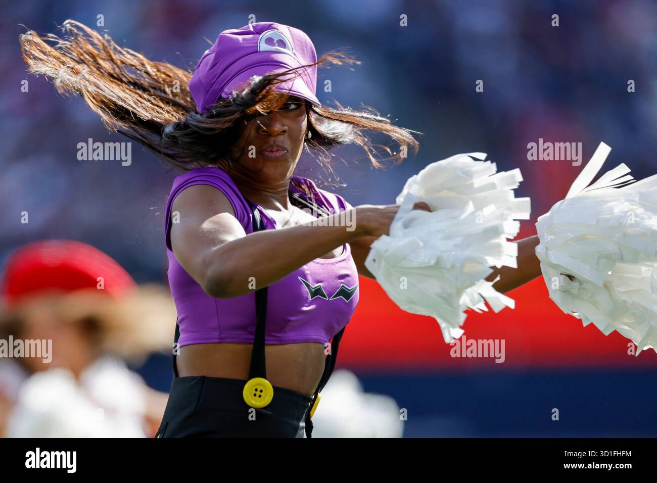 A New England Patriots cheerleader performs during the first half of an ...