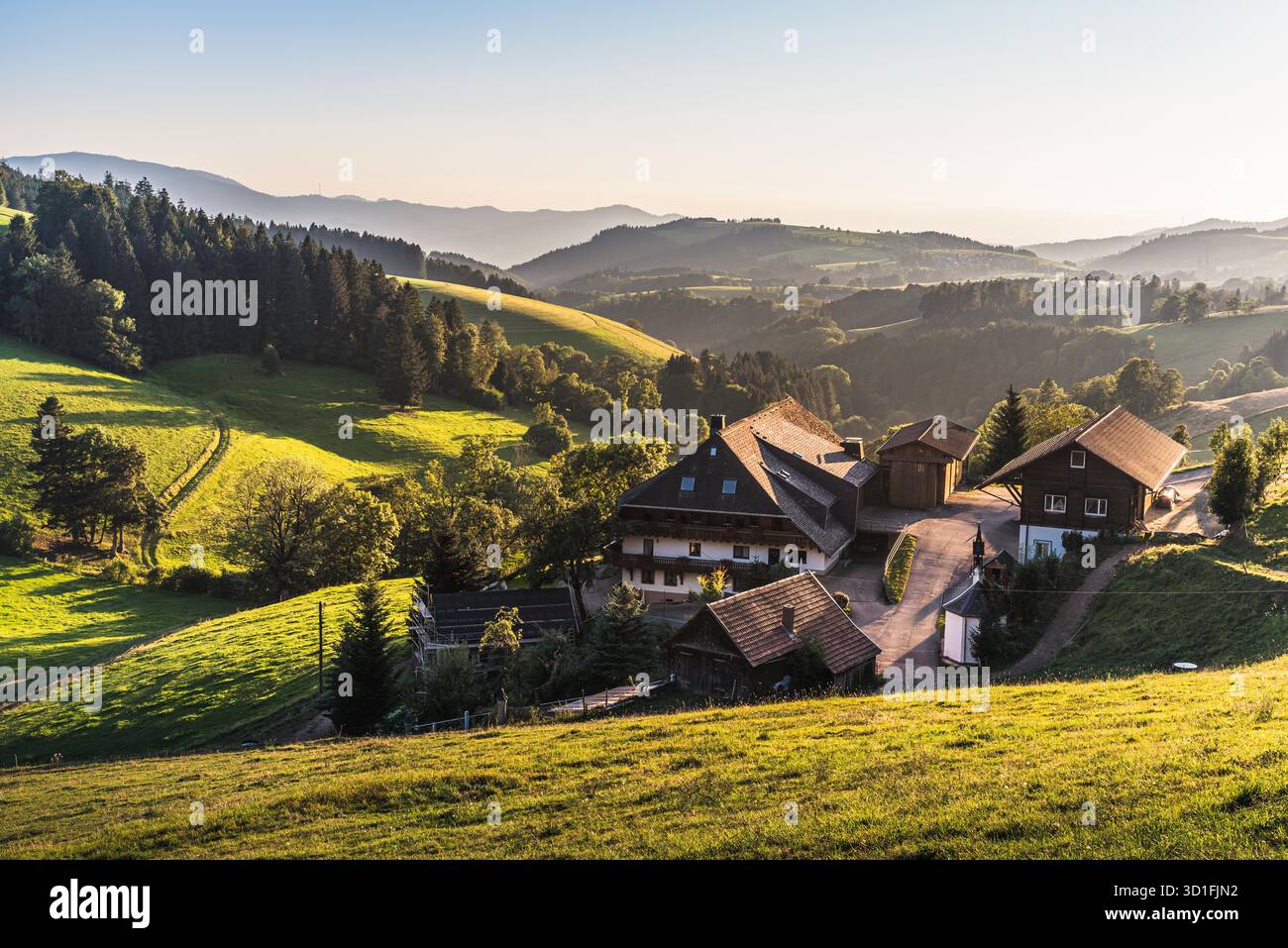 A picturesque farm is located in the midst of the gentle hills of the ...