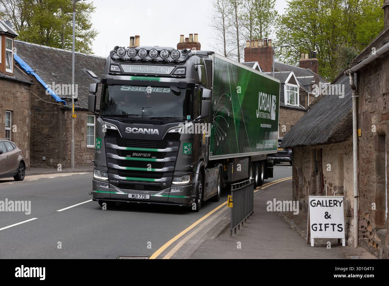 The narrow A77 road running through the village, and frequented by ...