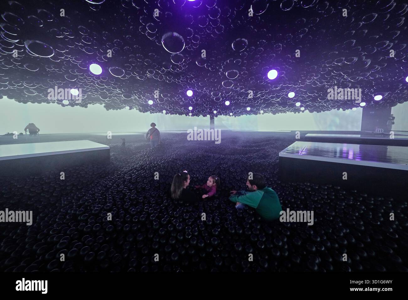Visitors enjoy a ball pit room at the Euphoria exhibit in the Balloon ...