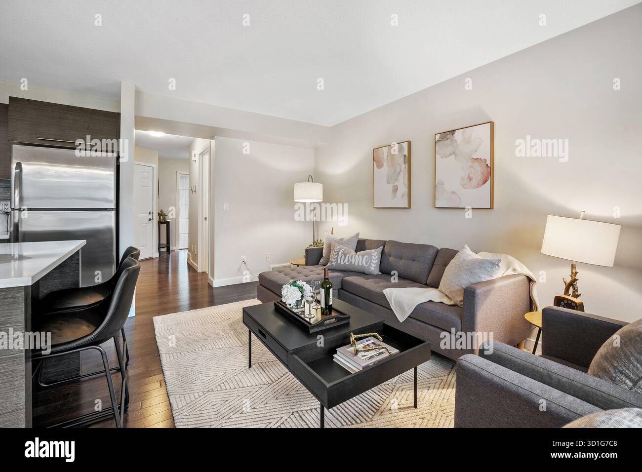 Living room with a couch, coffee table, and chairs. The couch is gray ...
