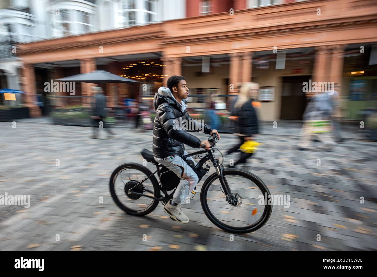 Brighton, October 28th 2025: A cyclist going past The Theatre Royal ...