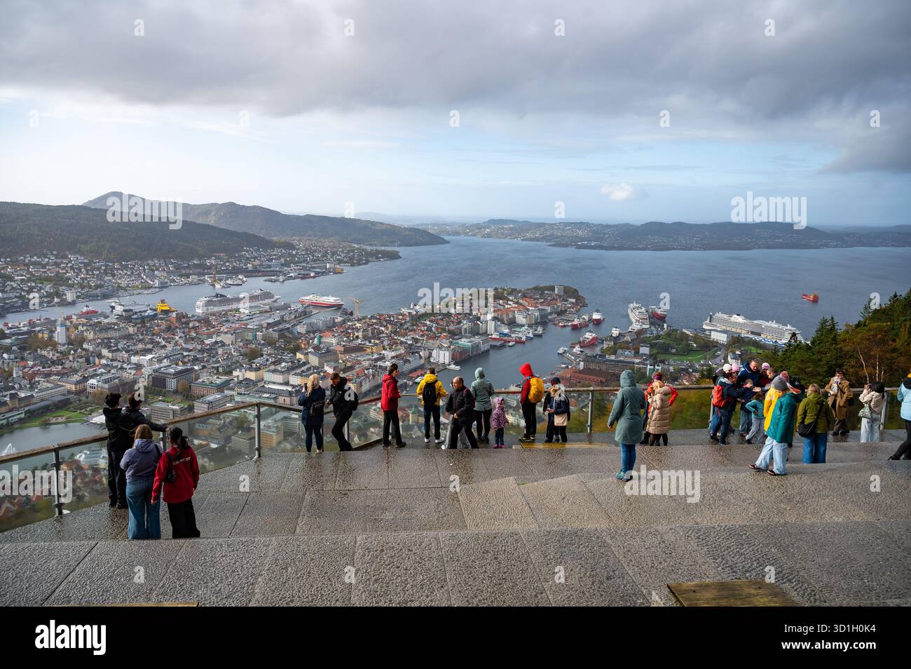 A group of people stands on a viewing platform overlooking Bergen ...