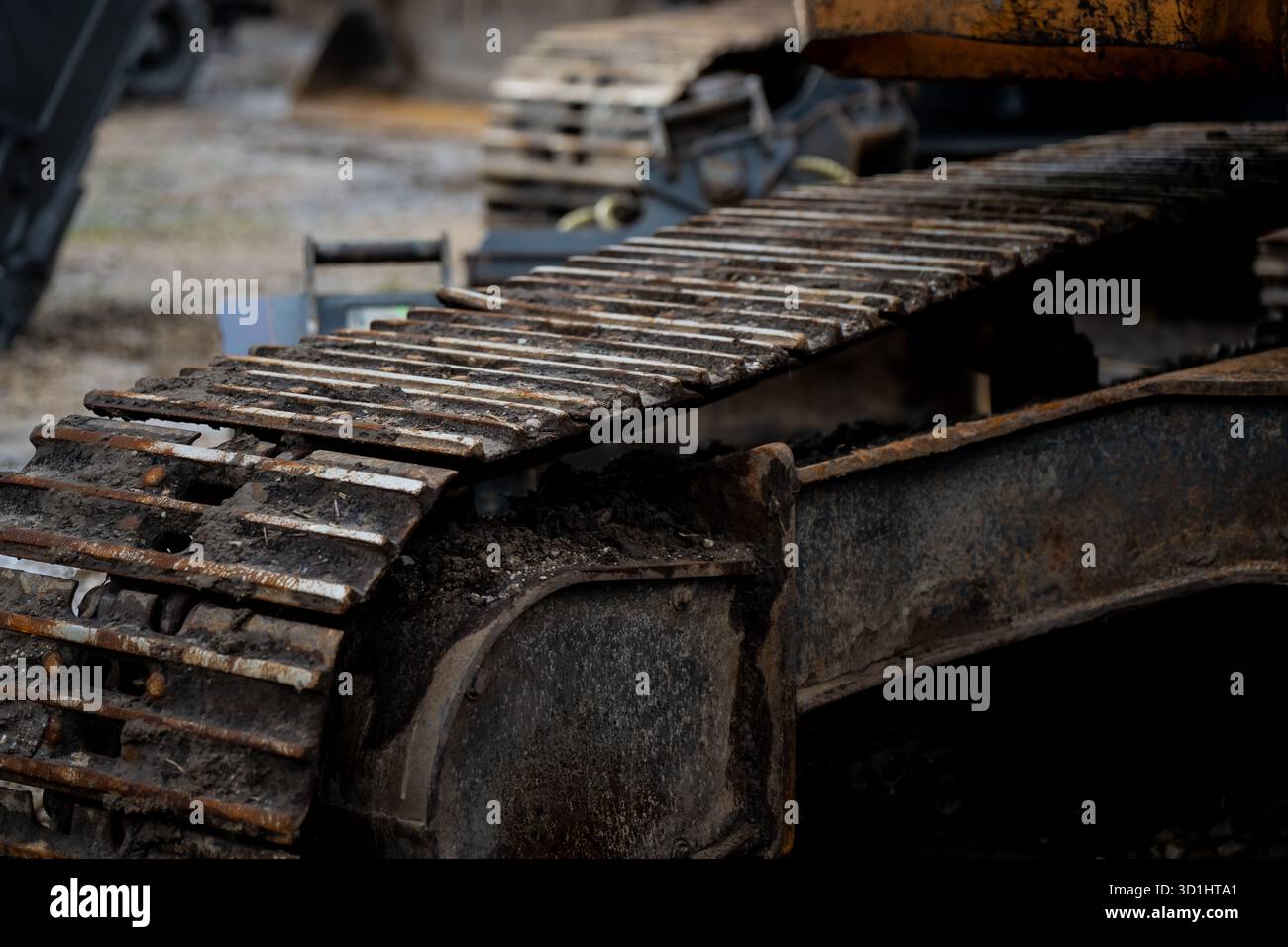 Heavy excavator track covered in dirt representing industrial strength ...