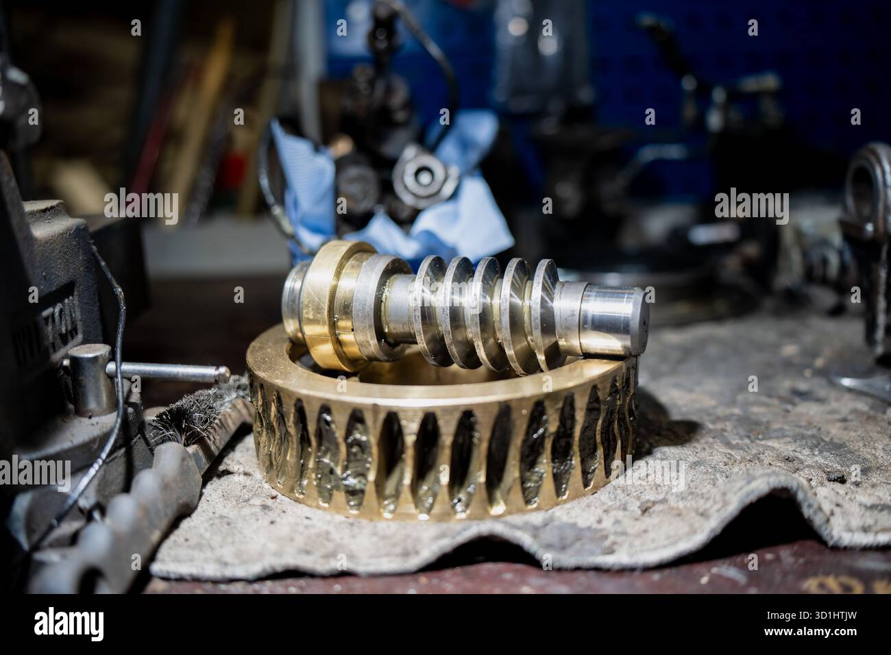 Metal worm gear and threaded shaft on workbench representing industrial ...