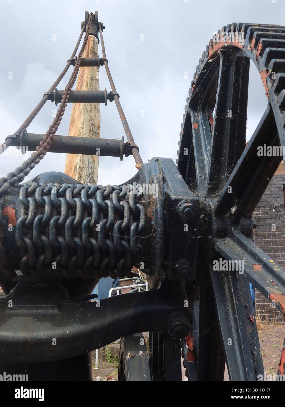 Industrial heritage: an historic large cast iron crane with wooden boom ...
