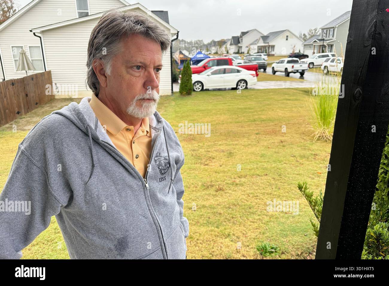 Terry Fuller stands on his porch as police process a crime scene two ...