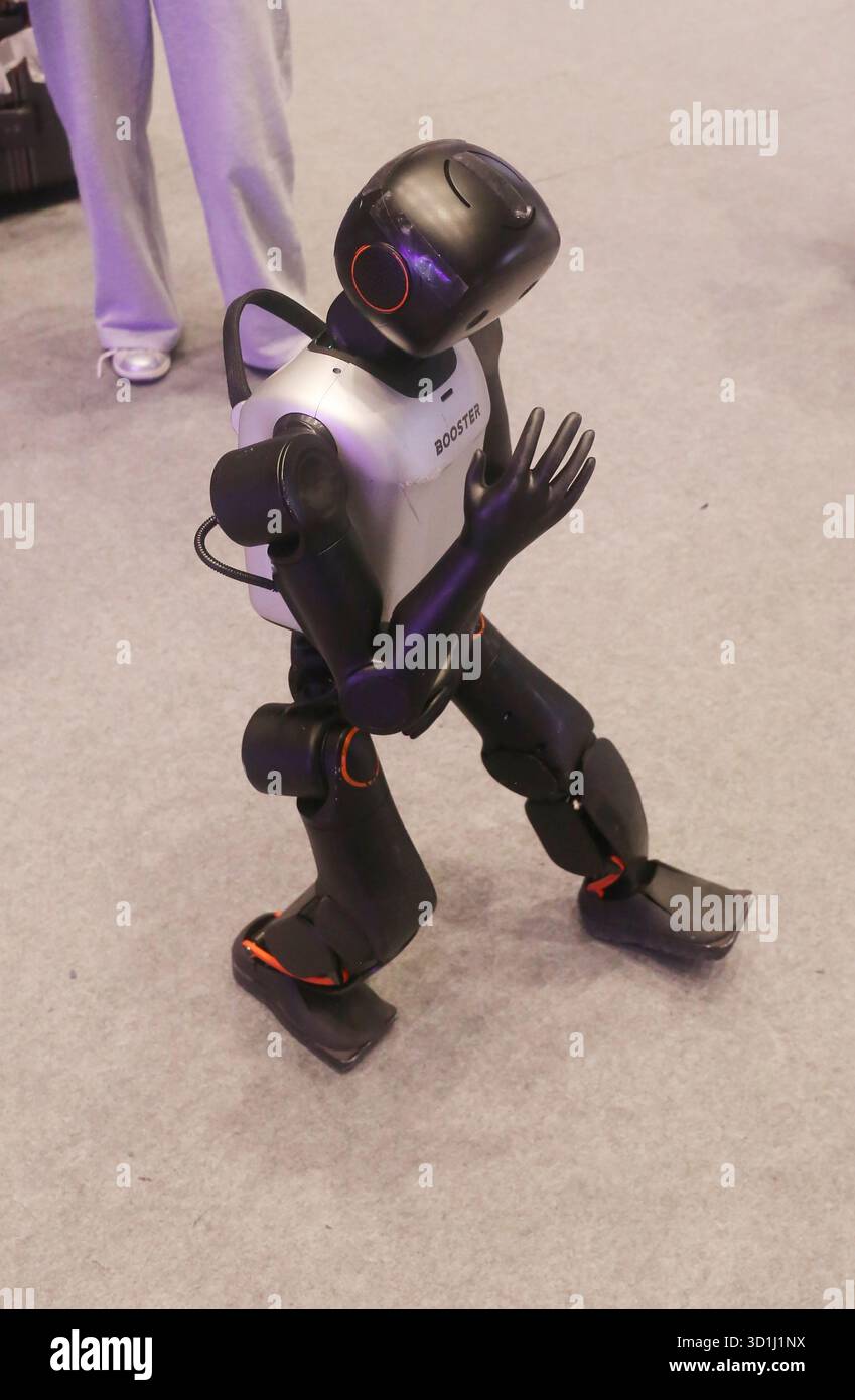 Tourists visit a BOOSTER K1 robot jumping Michael Jackson's MJ Moonwalk ...