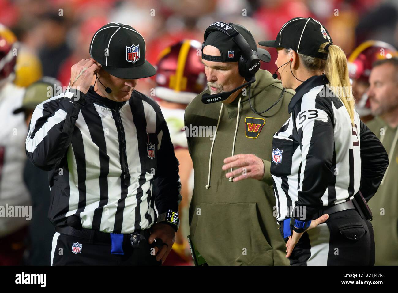 Washington Commanders head coach Dan Quinn talks to side judge Chad ...