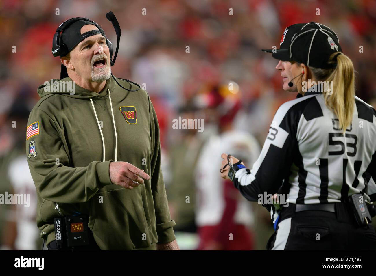 Washington Commanders head coach Dan Quinn talks to side judge Chad ...