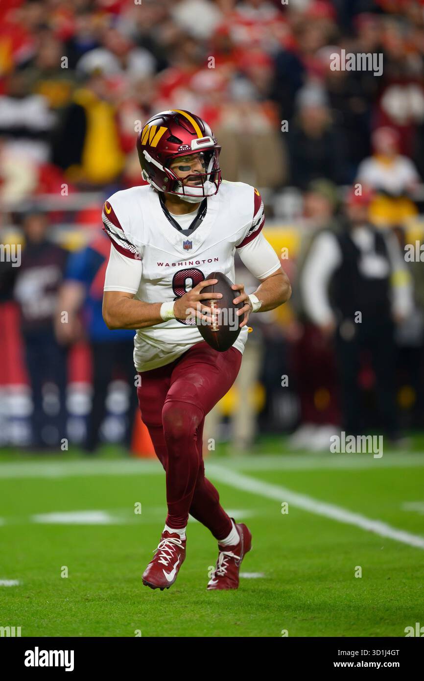 Washington Commanders quarterback Marcus Mariota scrambles away from ...