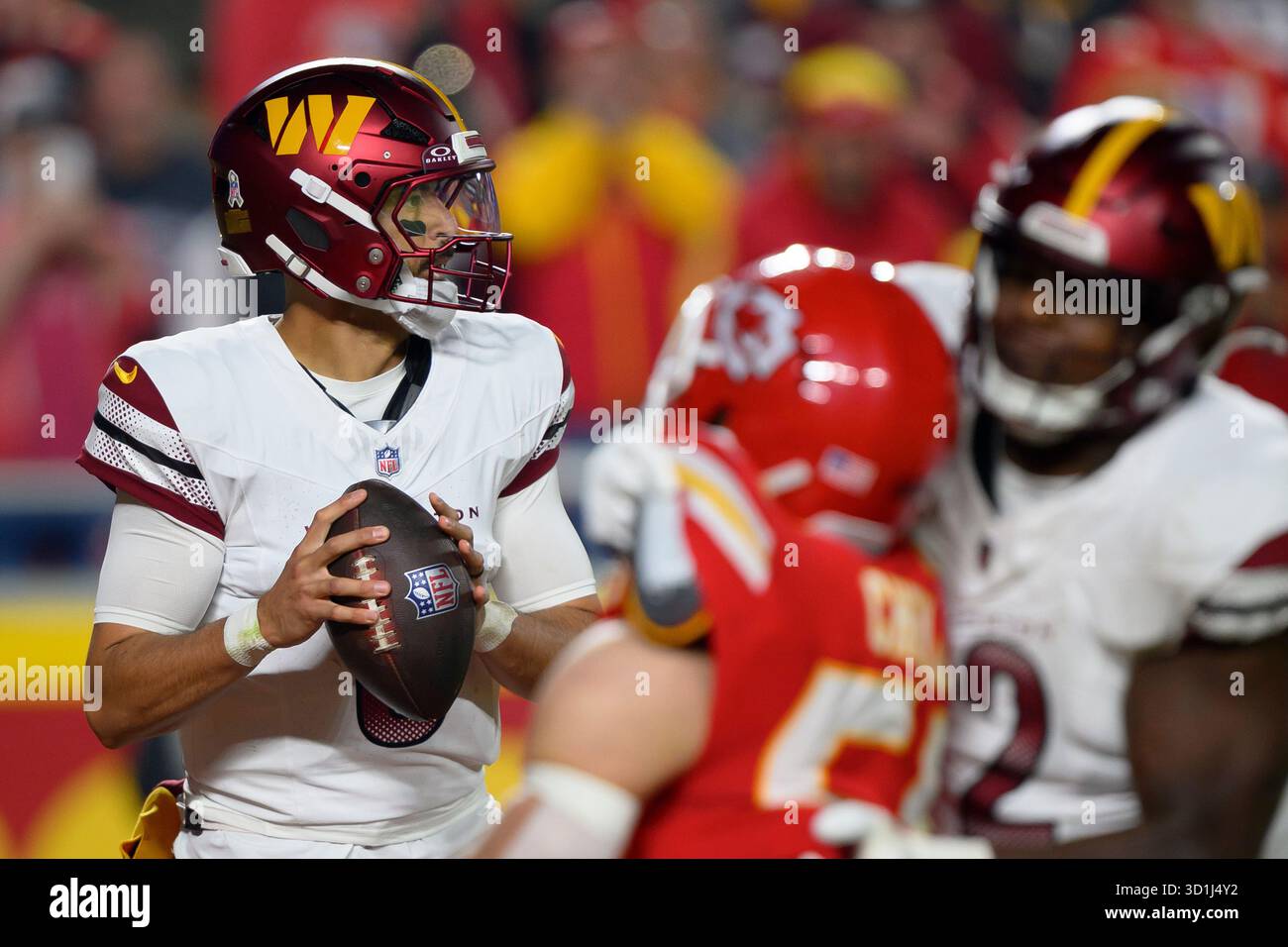 Washington Commanders quarterback Marcus Mariota looks to pass against ...