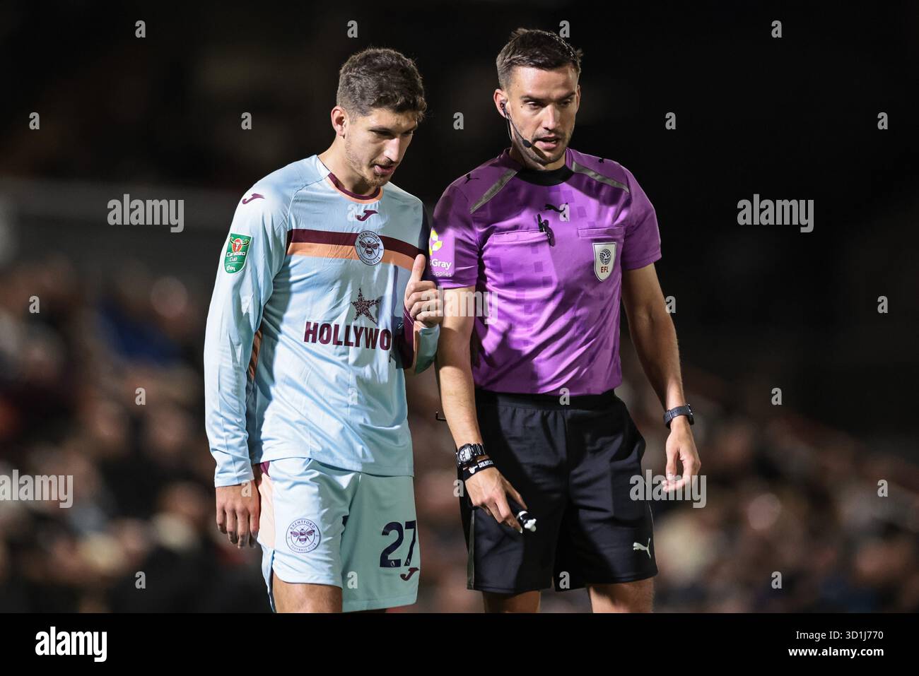 Vitaly Janelt of Brentford and referee Thomas Kirk during the Carabao ...