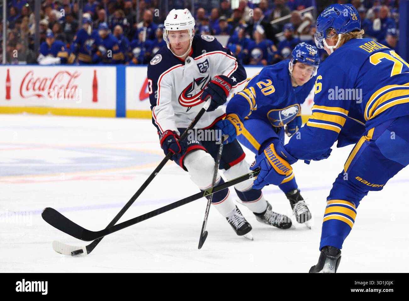Columbus Blue Jackets center Charlie Coyle (3) is pressured by Buffalo ...