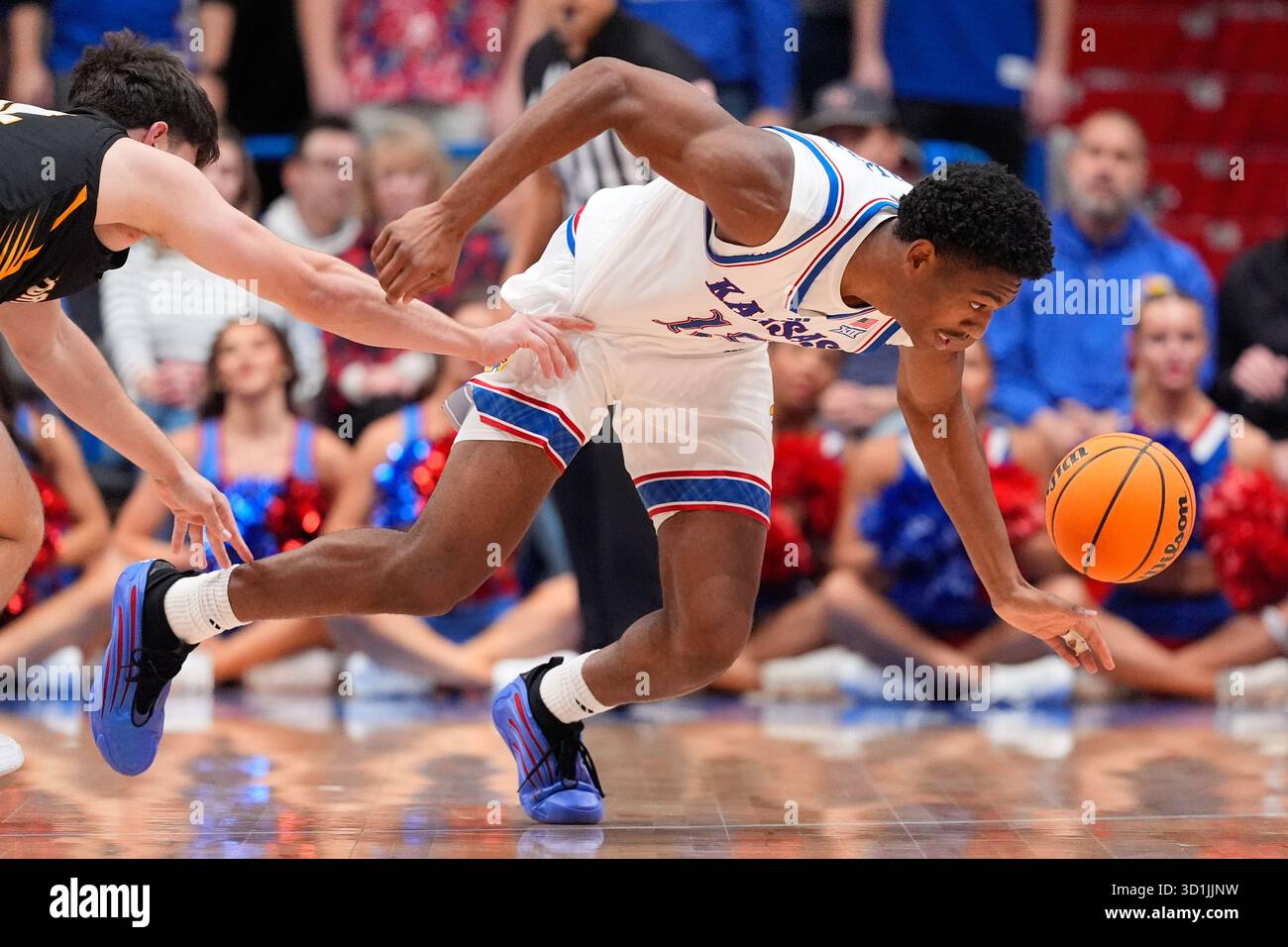 Kansas forward Bryson Tiller chases after a loose ball during the first ...