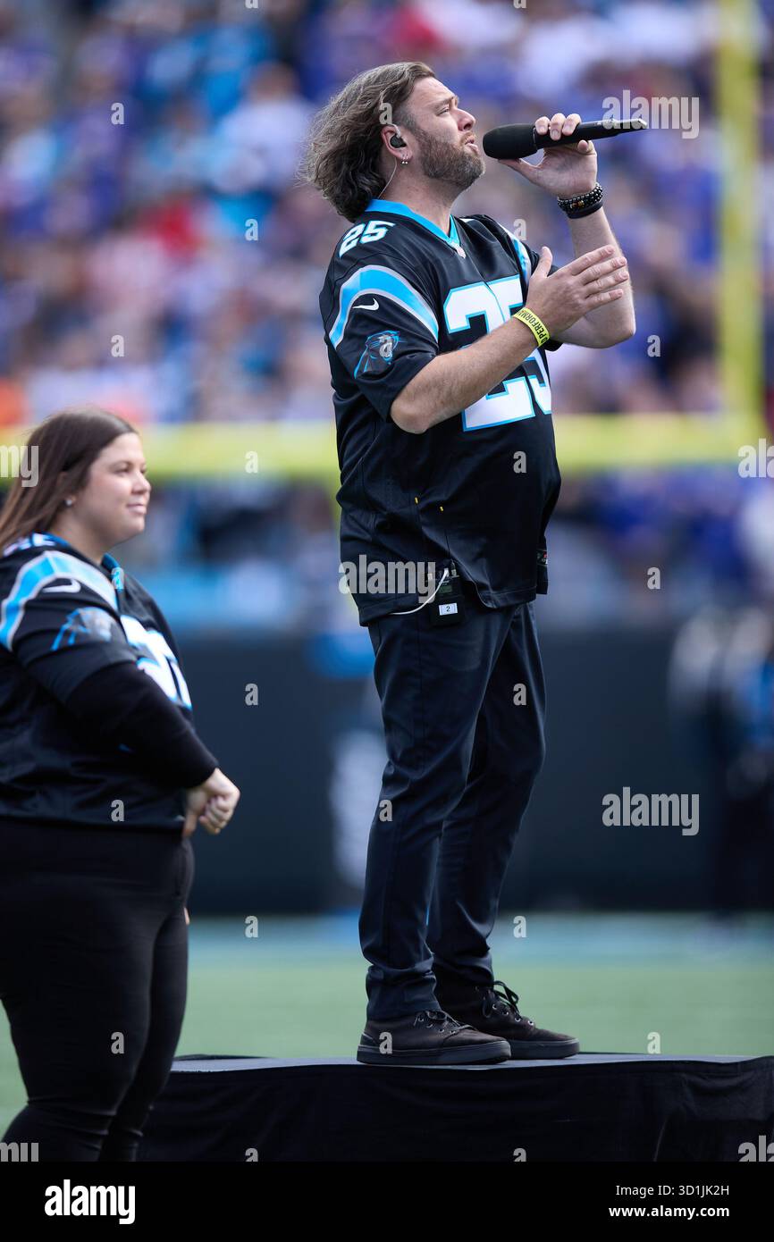 Adam Lee Decker sings the National Anthem prior to an NFL football game ...