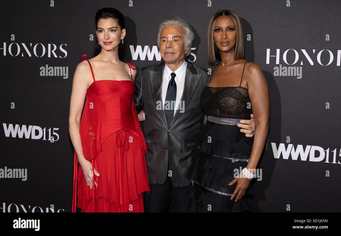 Anne Hathaway, from left, Giancarlo Giammetti, and Iman attend the WWD ...