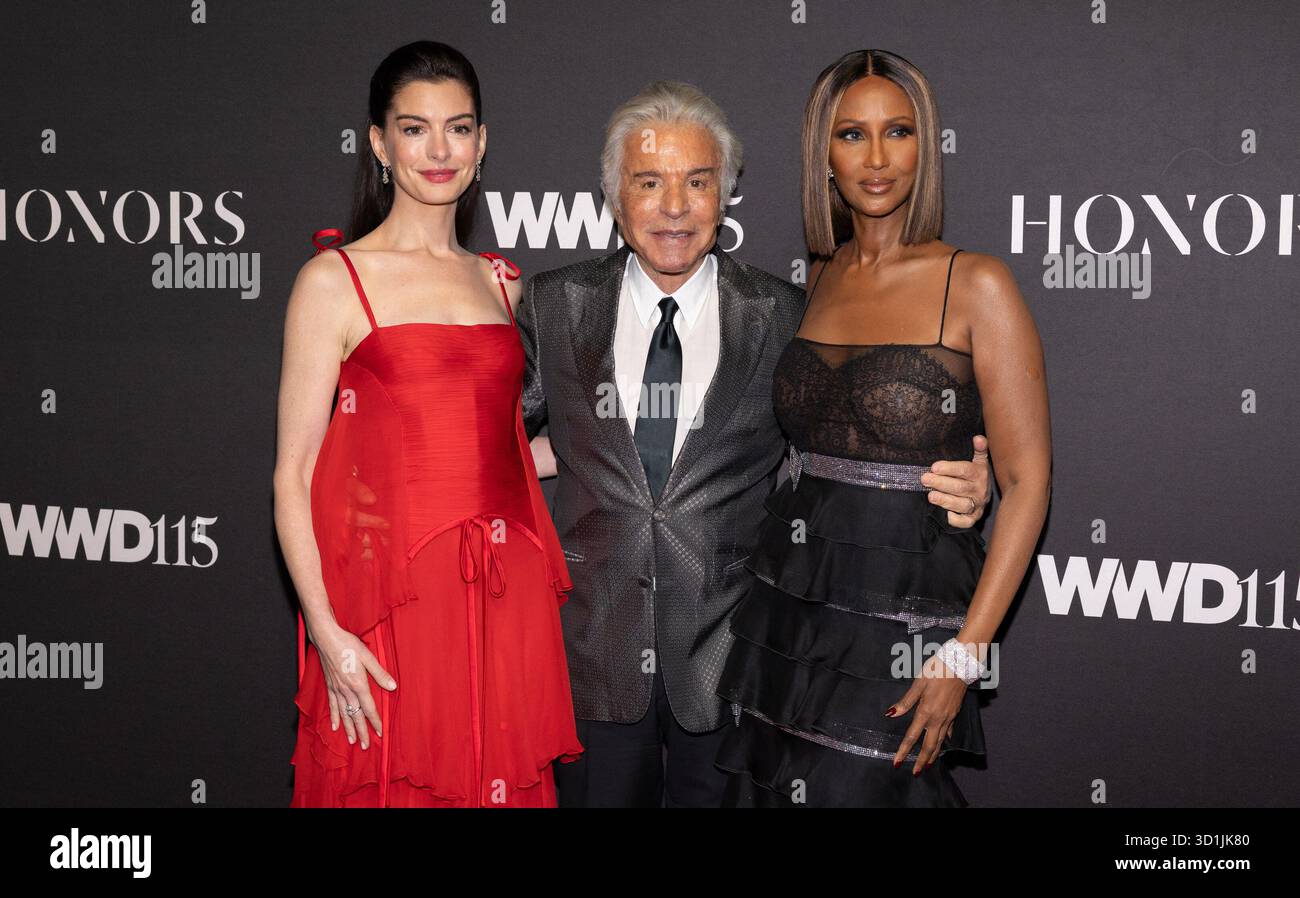 Anne Hathaway, from left, Giancarlo Giammetti, and Iman attend the WWD ...