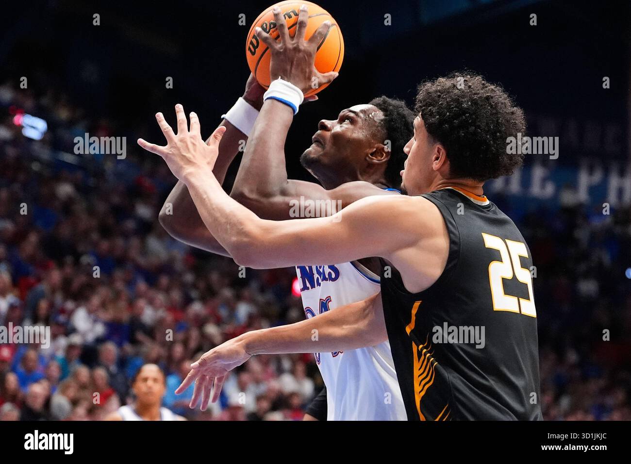 Kansas center Paul Mbiya shoots under pressure from Fort Hays State ...
