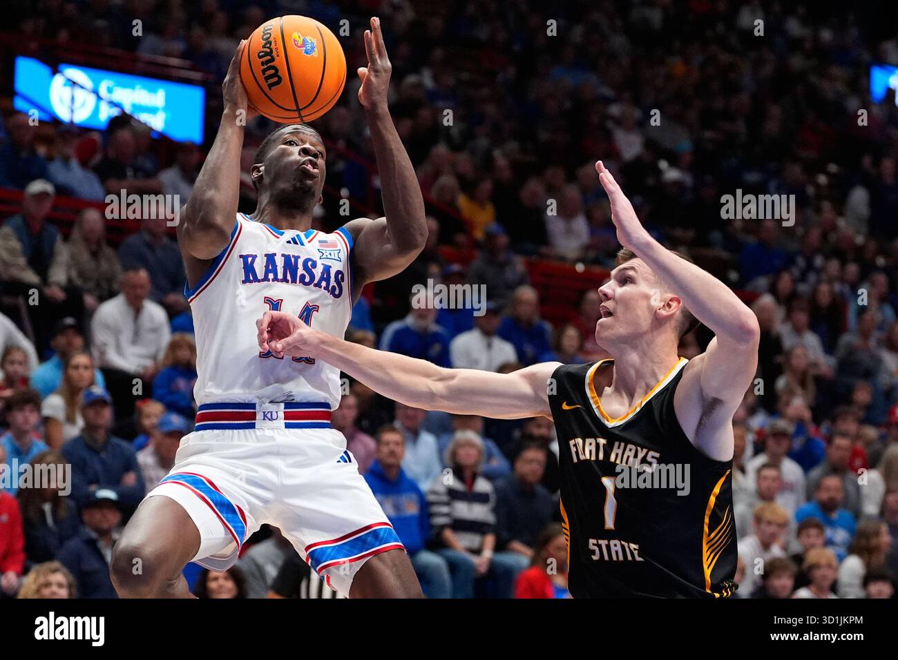 Kansas guard Melvin Council Jr. (14) shoots over Fort Hays State guard ...