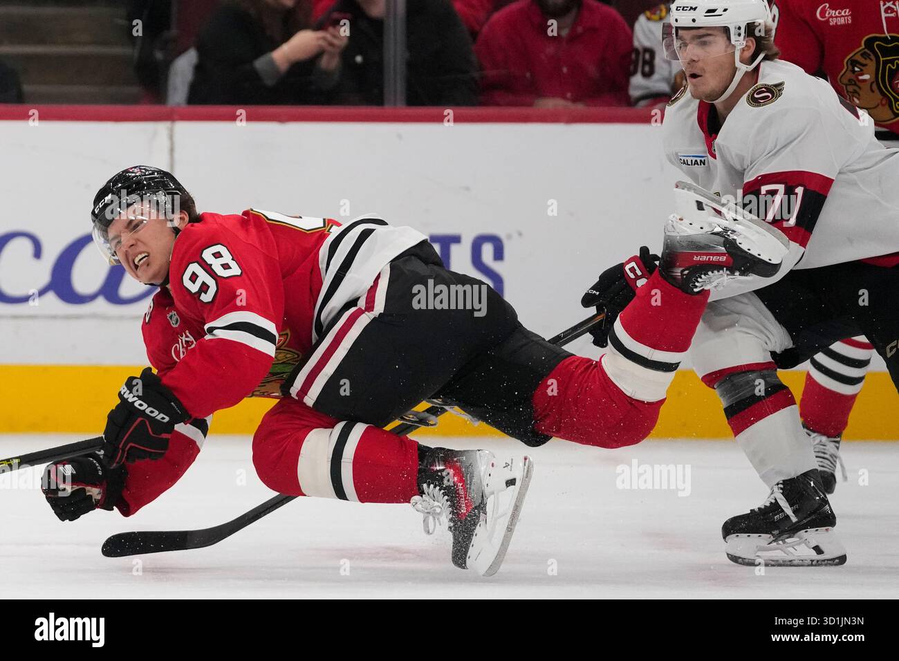 Ottawa Senators center Ridly Greig (71), right, trips Chicago ...
