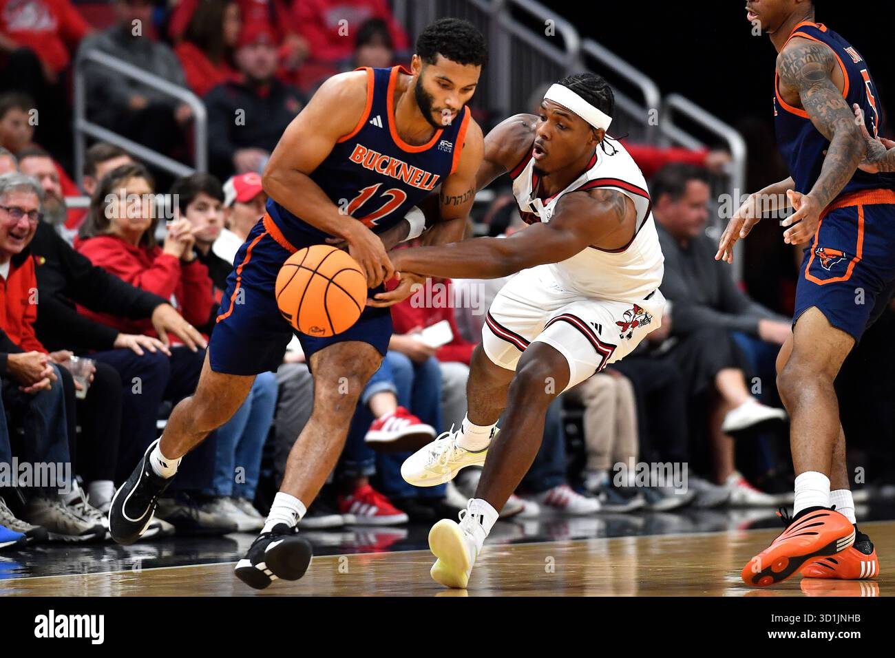 Louisville guard Ryan Conwell (3) attempts to strip the ball away from ...