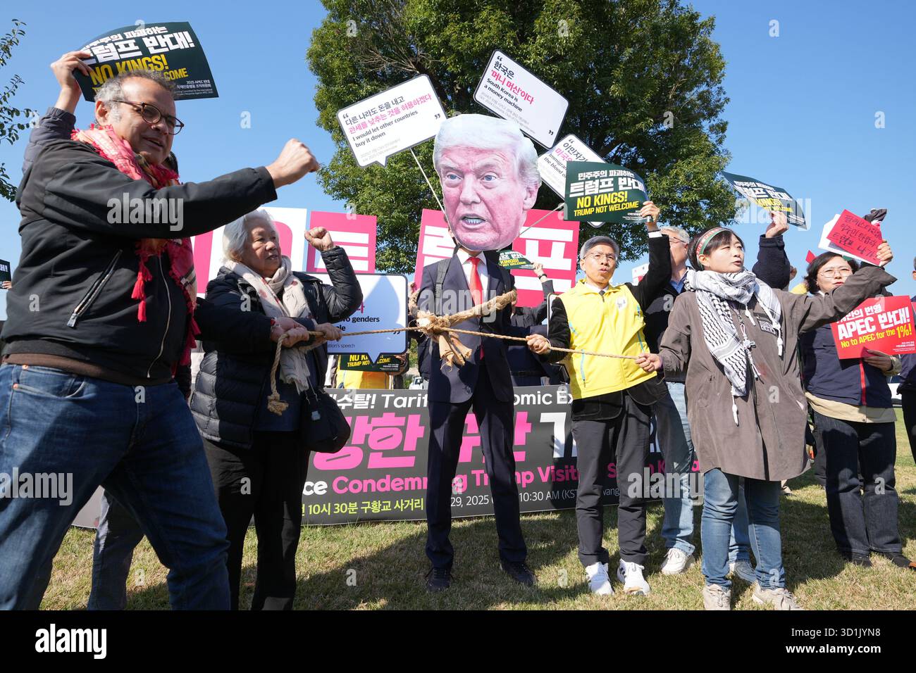 A protester wearing a mask of U.S. President Donald Trump and others ...
