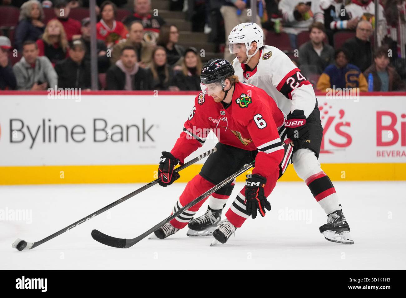 Chicago Blackhawks defenseman Sam Rinzel (6), left, and Ottawa Senators ...