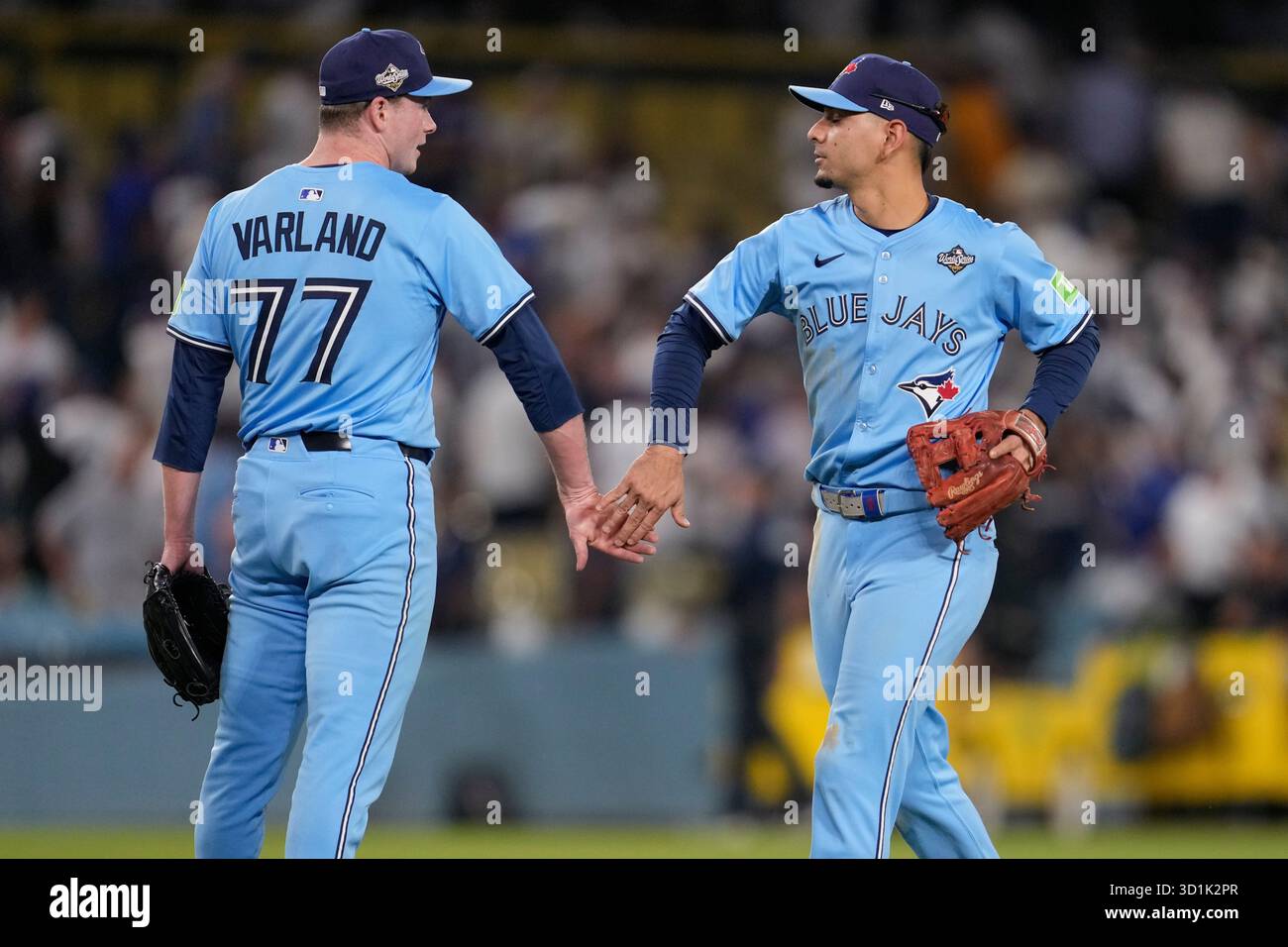 Toronto Blue Jays' pitcher Louis Varland (77) greets Toronto Blue Jays ...