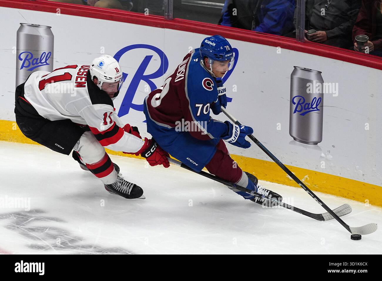 Colorado Avalanche defenseman Sam Malinski, right, collects the puck as ...