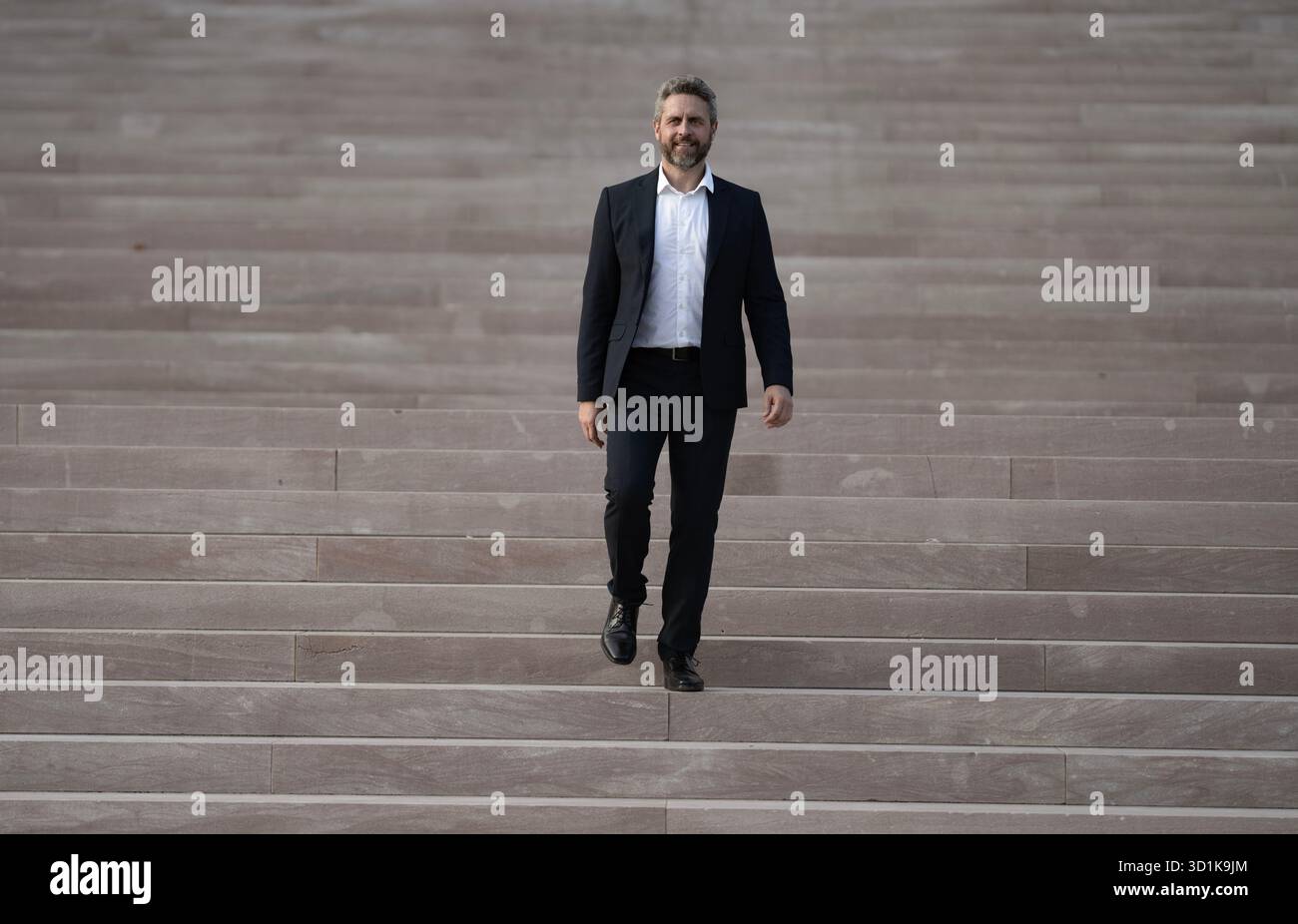 Business man walking up stairs as a symbol of career growth and success ...