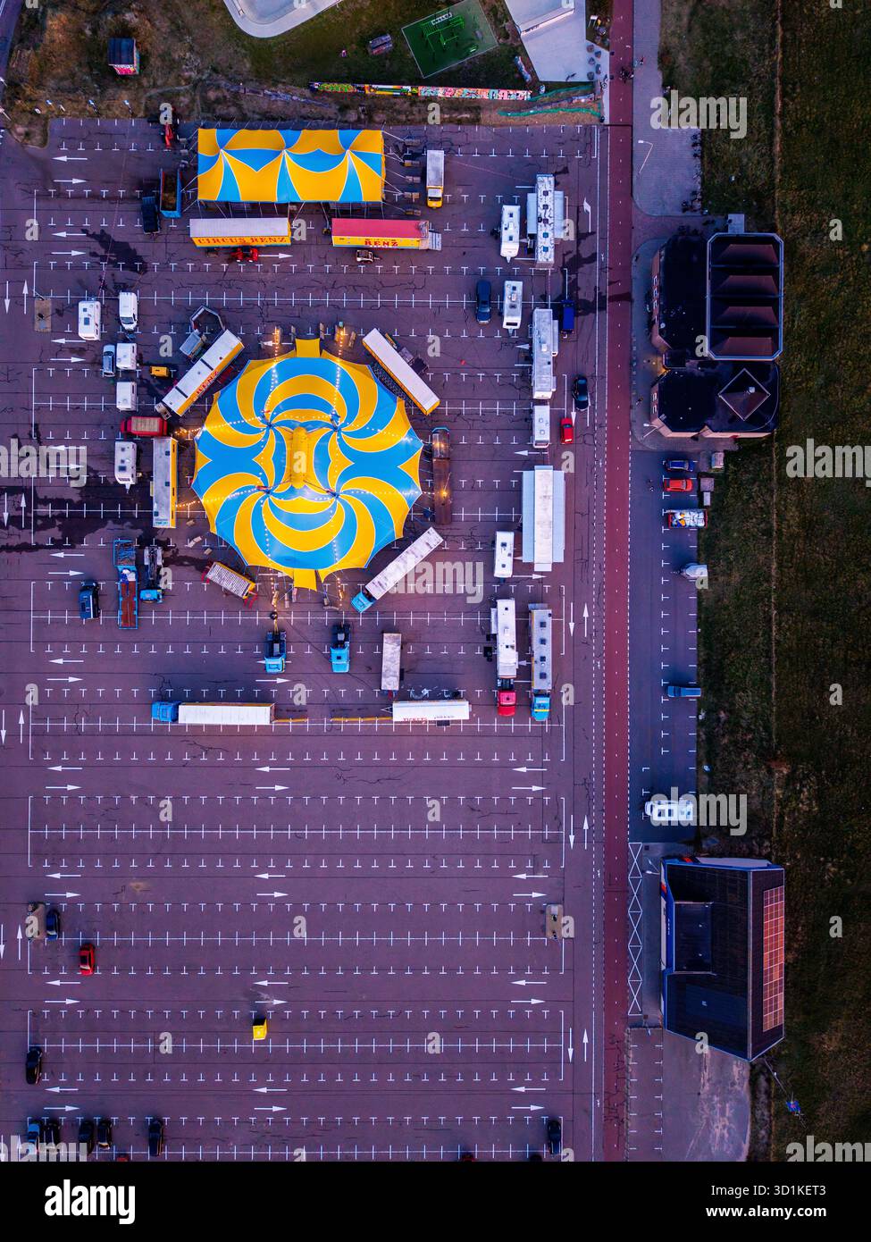 Aerial view of vibrant circus setup in parking lot blue yellow spiral ...