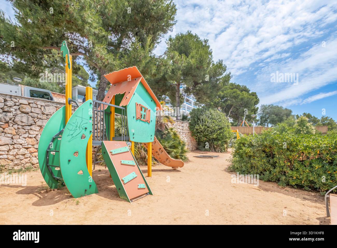 A colorful children's playground structure with slides and a climbing ...