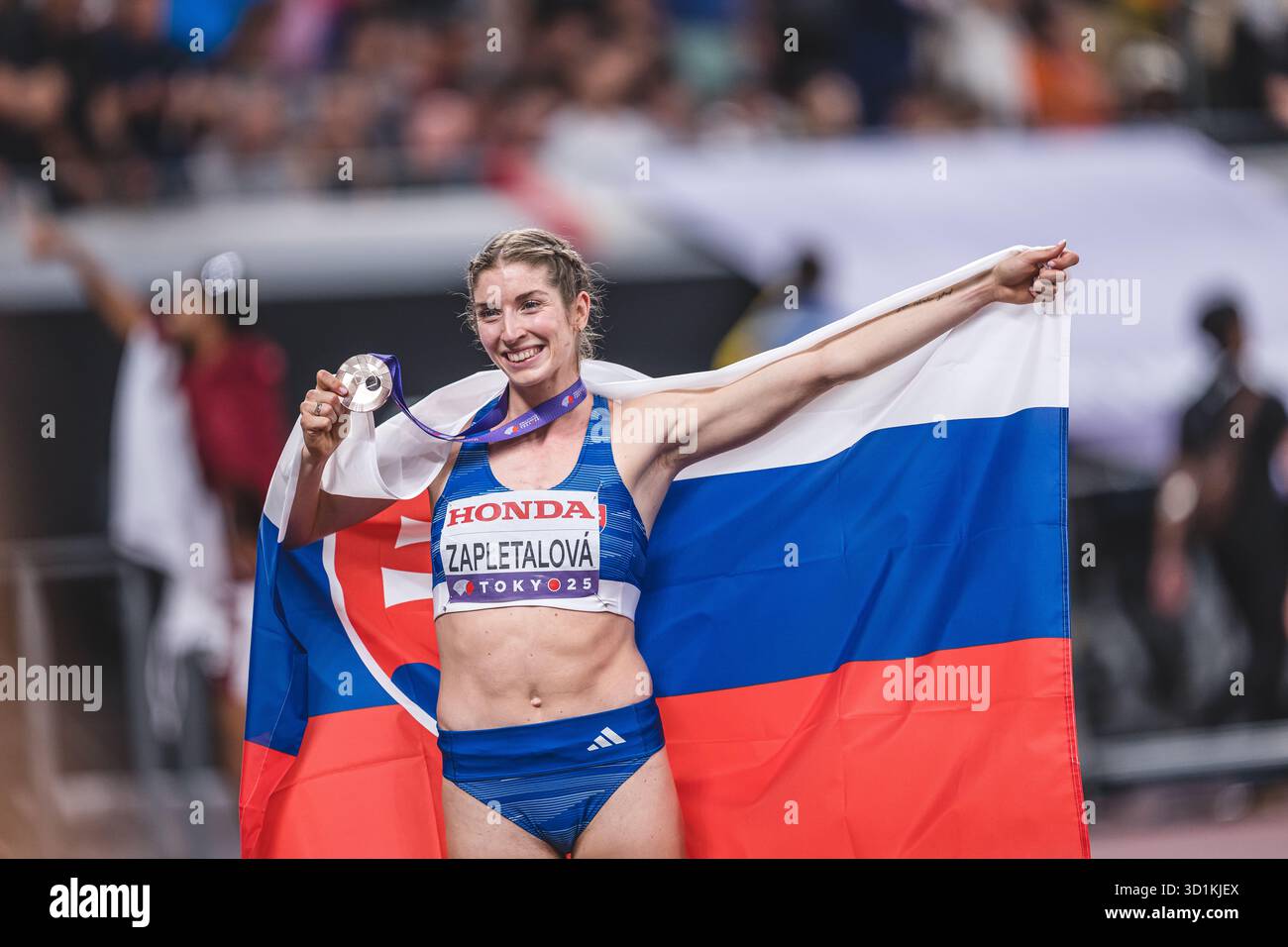 Emma Zapletalová celebrating her medal with her country's flag at the ...