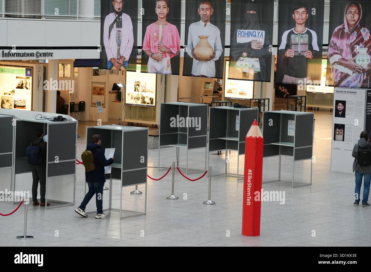 People vote at a polling station during general elections in The Hague ...