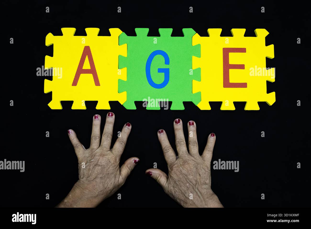 awareness message on aging using puzzle tiles and hands of an older ...