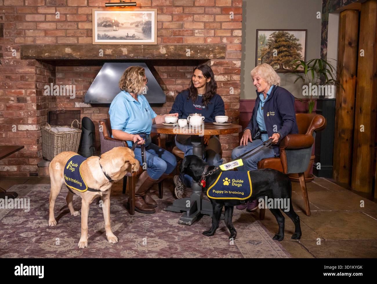 EDITORIAL USE ONLY Volunteer puppy-handlers Alison Davis (left), with ...