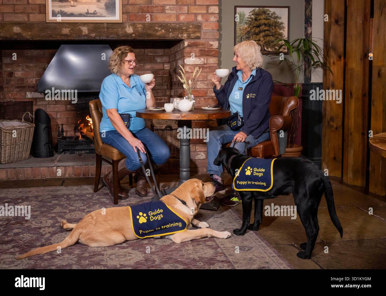 EDITORIAL USE ONLY Volunteer puppy-handlers Alison Davis (left), with ...