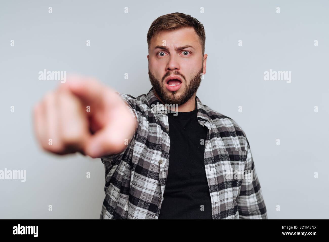 Surprised man pointing at camera with open mouth Stock Photo - Alamy