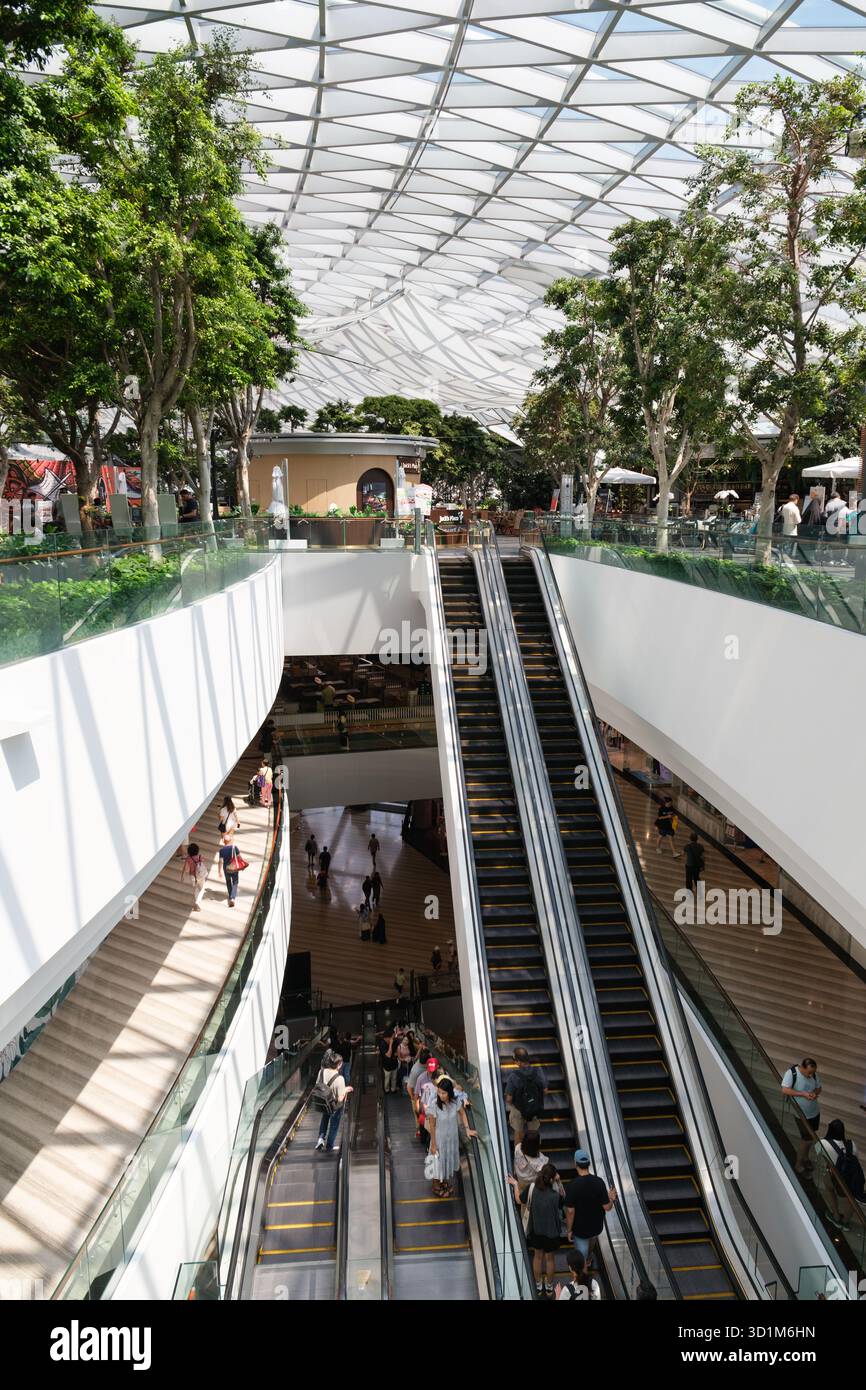 Changi Airport showcases a modern architectural design with escalators ...