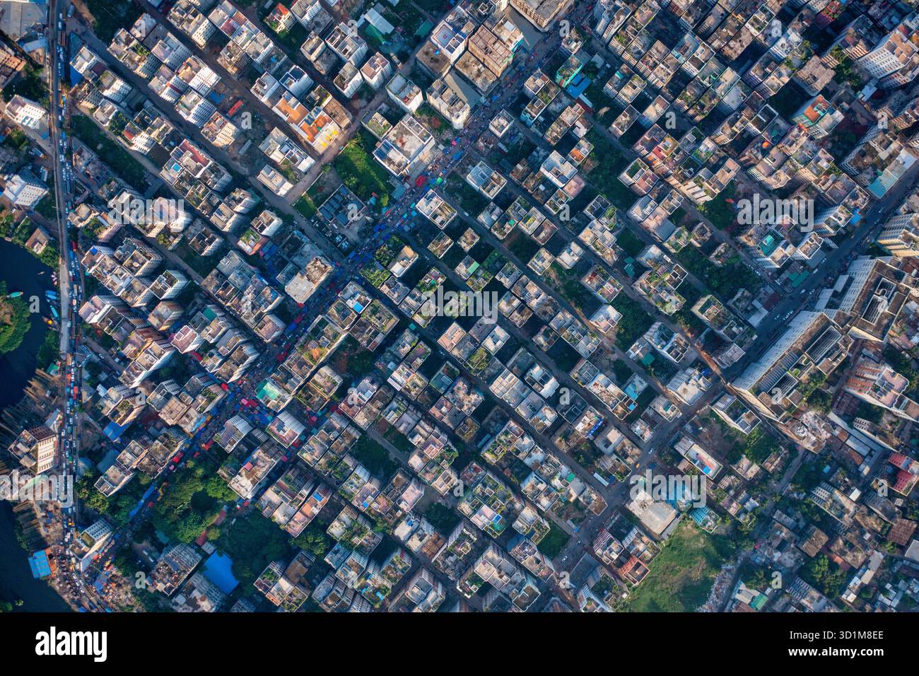 Aerial view of tightly packed buildings casting long shadows, revealing ...