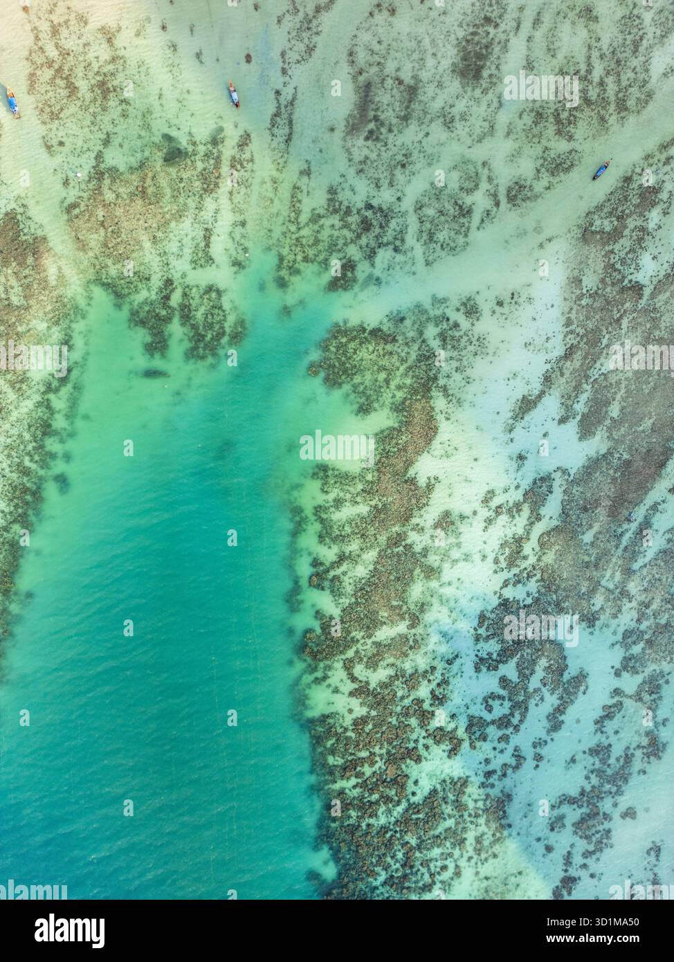 Aerial view of turquoise waters meet textured coral reefs in a stunning ...