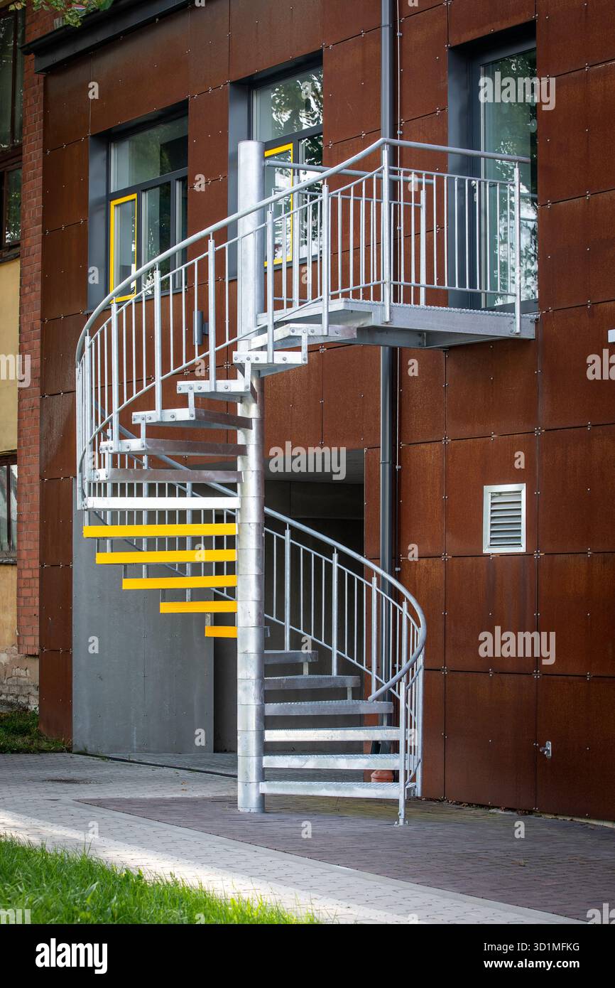 Modern exterior spiral staircase made of galvanized steel with yellow ...