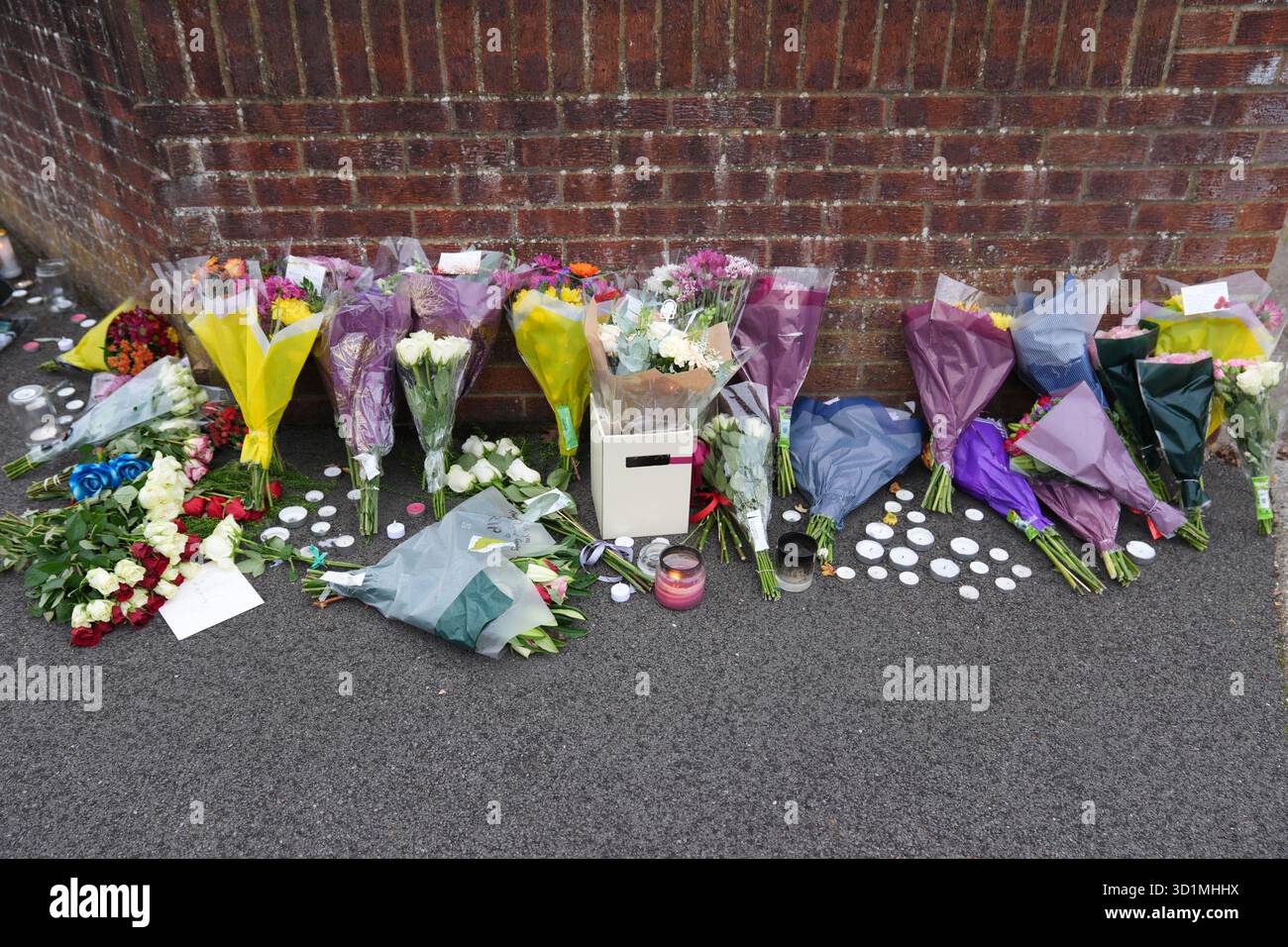 Flowers left near the scene in Midhurst Gardens in Uxbridge, west ...