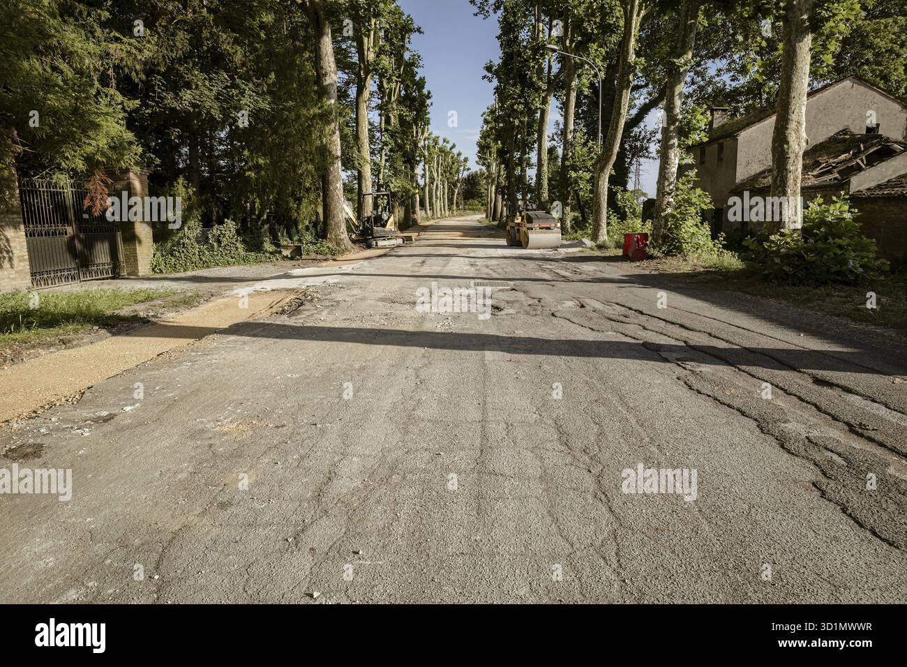 A photo capturing a broken road in Italy undergoing repair and ...